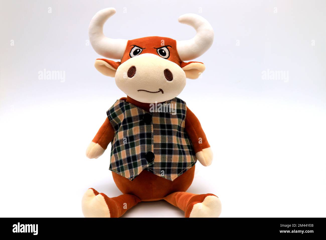Funny toy orange Bull sits on a white background. Beautiful bull with ...