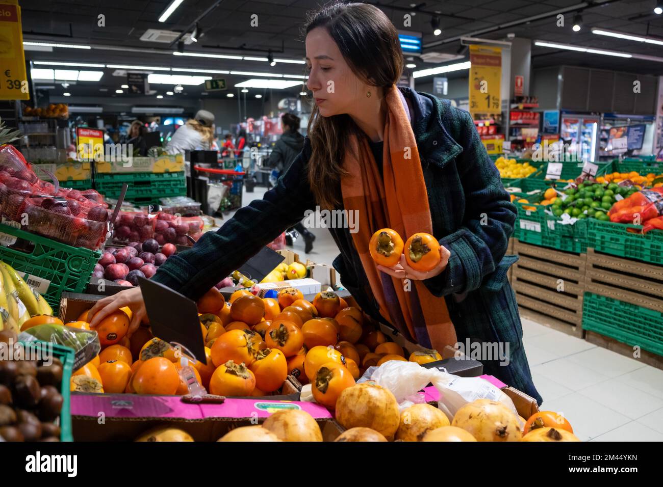 Woman choosing fruits hi-res stock photography and images - Alamy