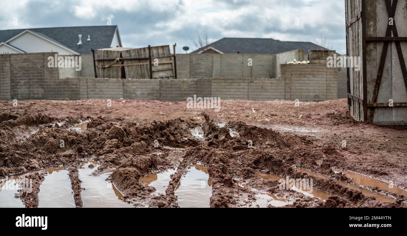 residential house construction under rain delay with mud and tracks ...