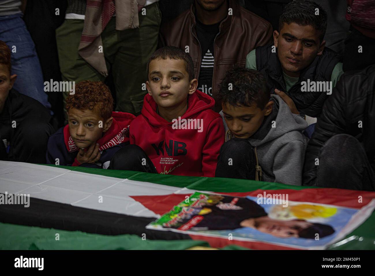 Palestinian children sit next to the bodies of 4 people ; Mohammed ...