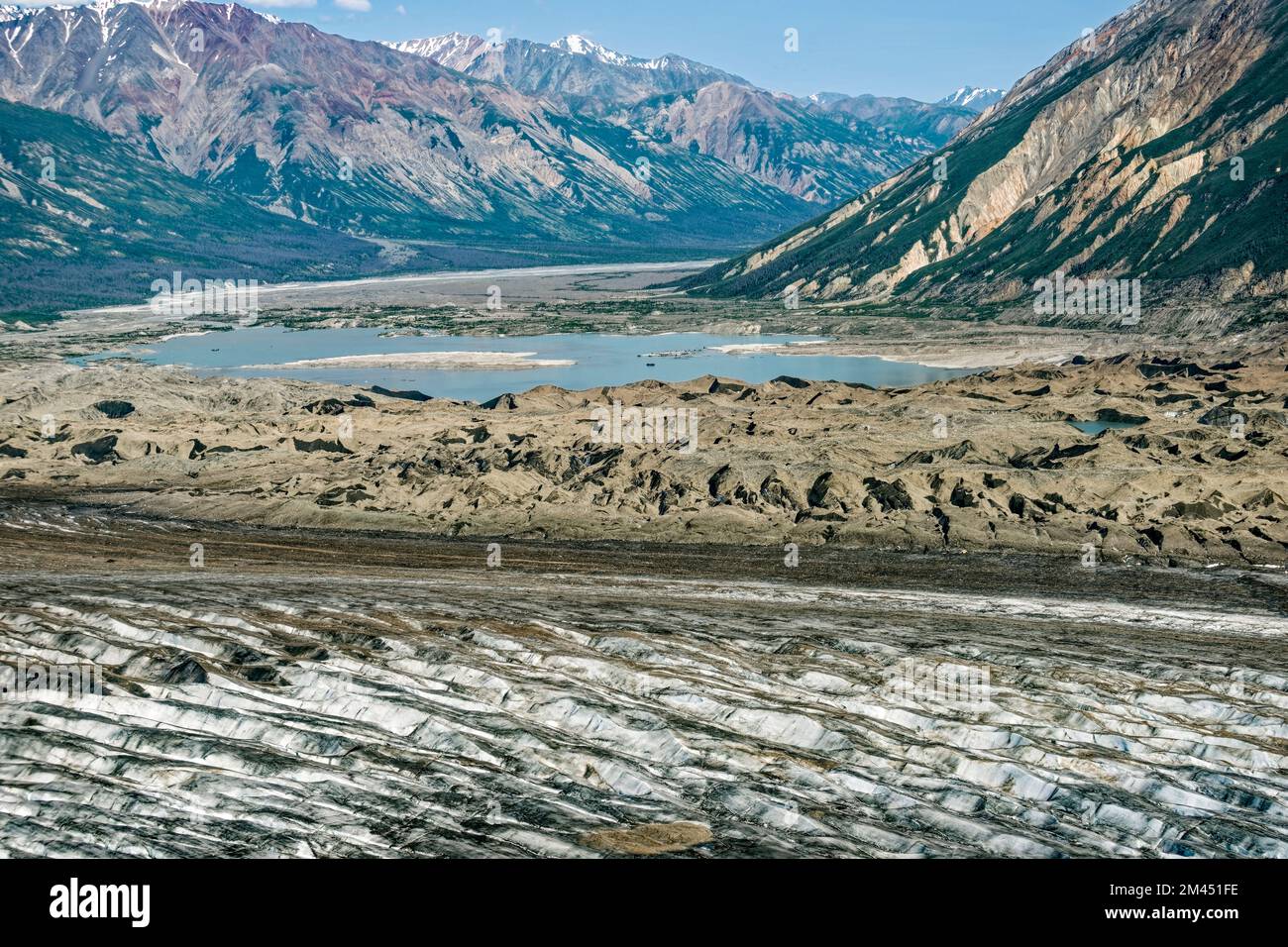A blue lake adjacent to the Kaskawulsh Glacier in Kluane National Park ...