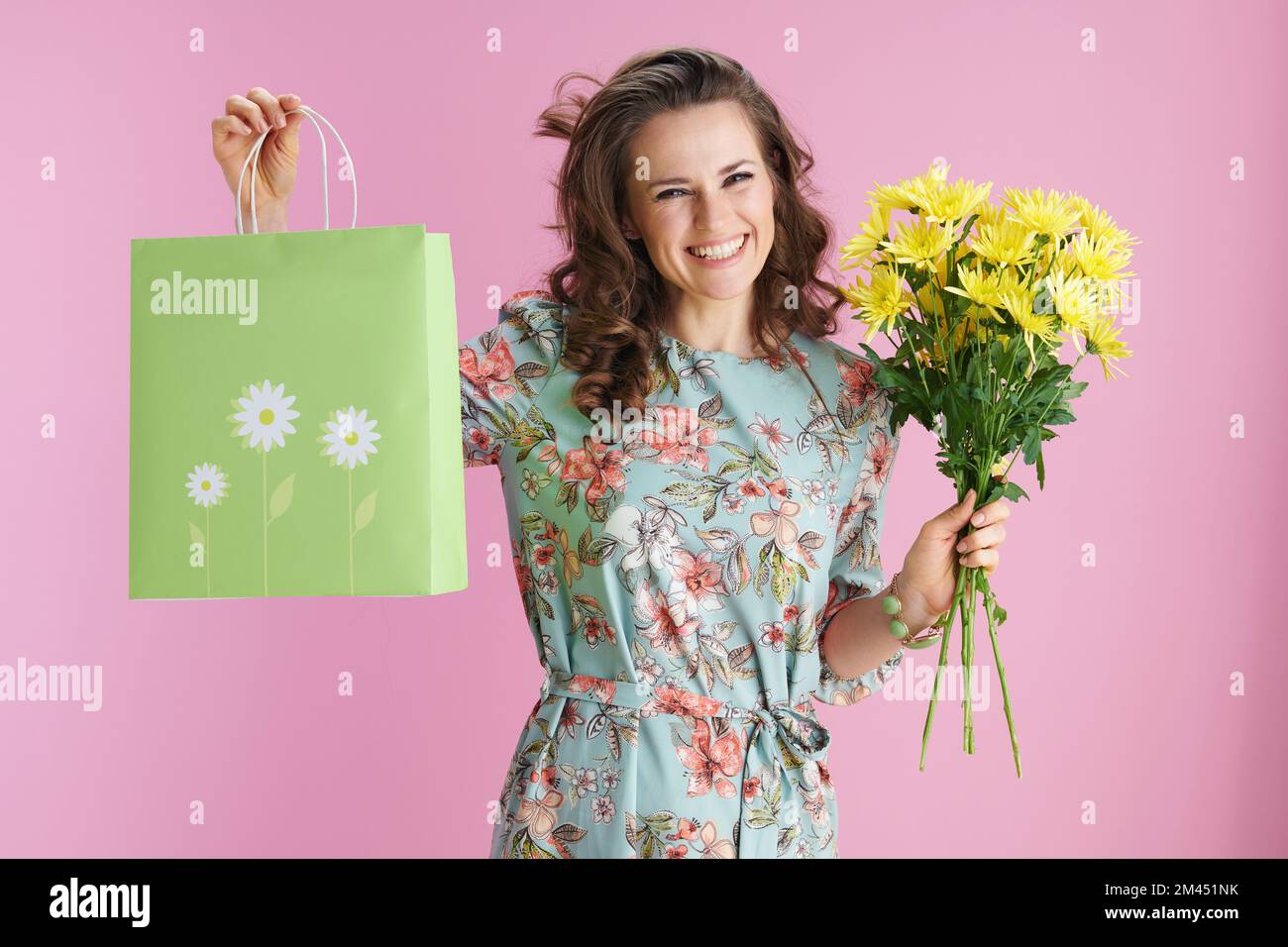 happy stylish female with long wavy brunette hair with yellow ...