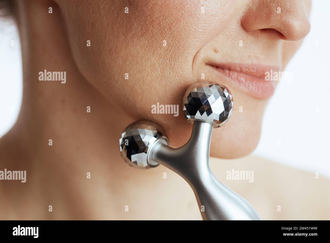 Closeup on young woman with massager isolated on white background Stock ...
