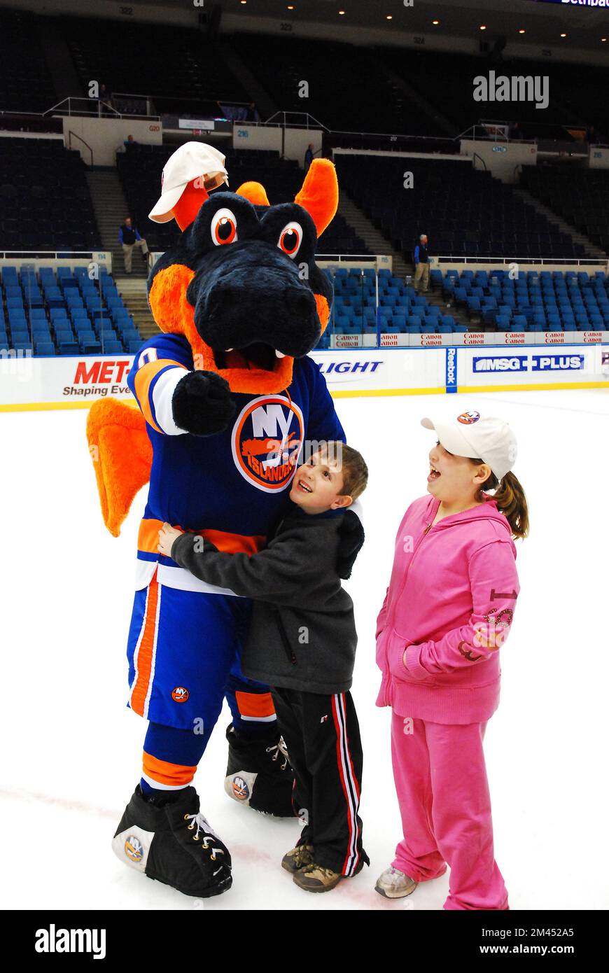 Two children greet Sparky, the dragon mascot for the NHL New York ...