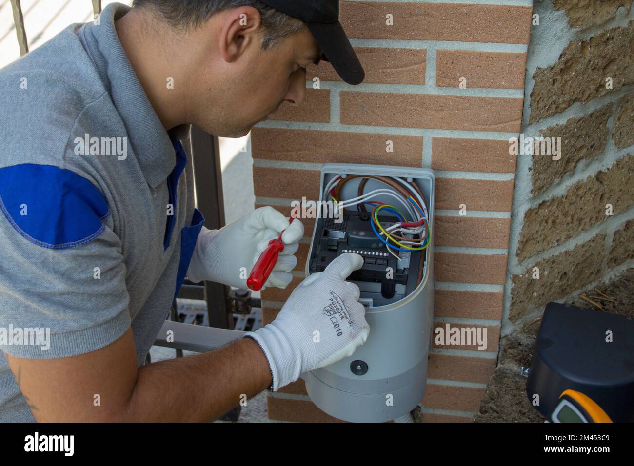 Electrician technician carrying out the repair and programming of a ...