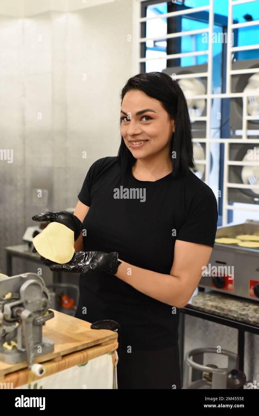 Mexican woman showing tacos during cooking in the kitchen Stock Photo ...