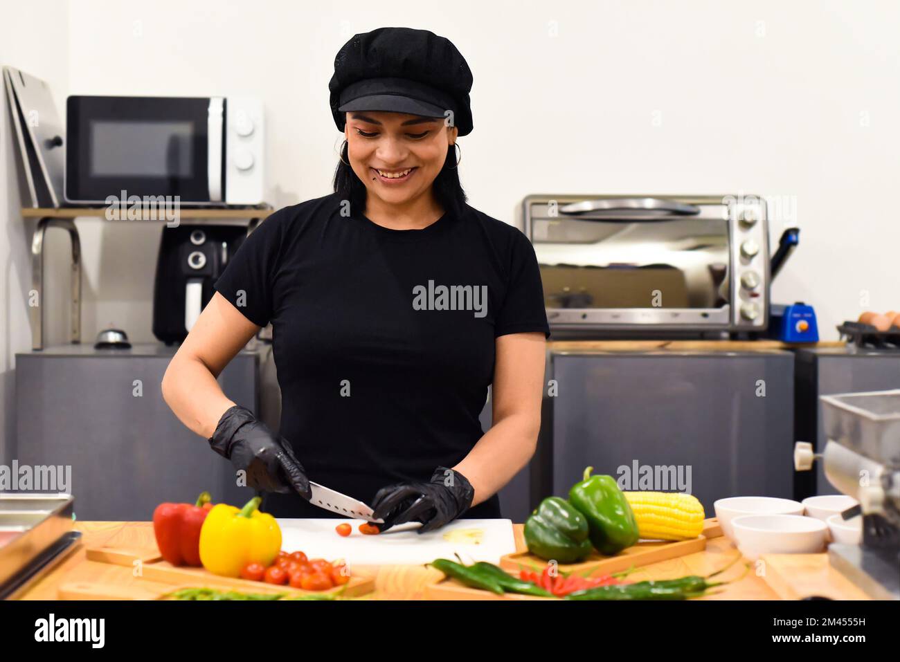 Mexican woman laughing during cooking tacos in the kitchen Stock Photo ...