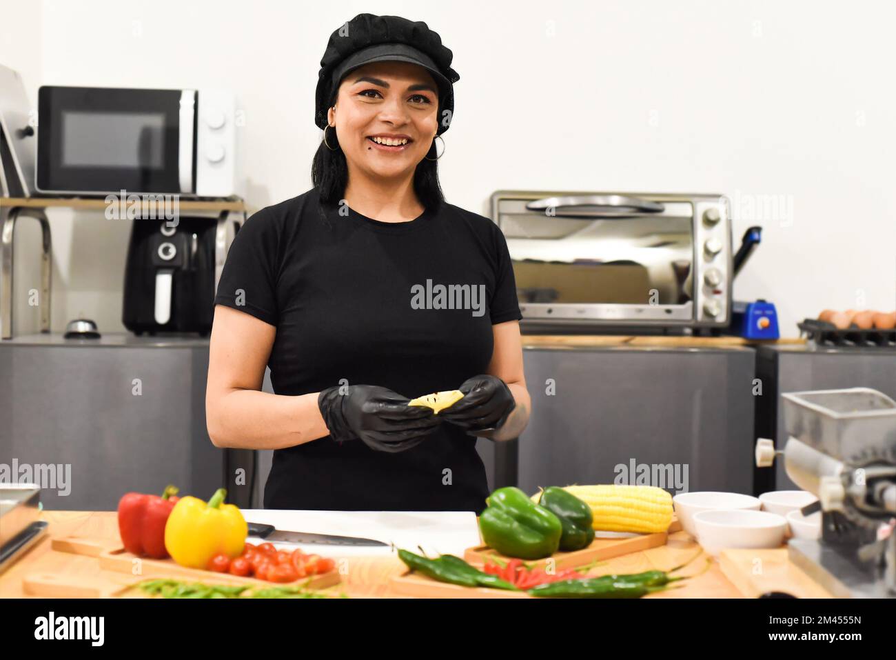 Mexican woman laughing during cooking tacos in the kitchen Stock Photo ...