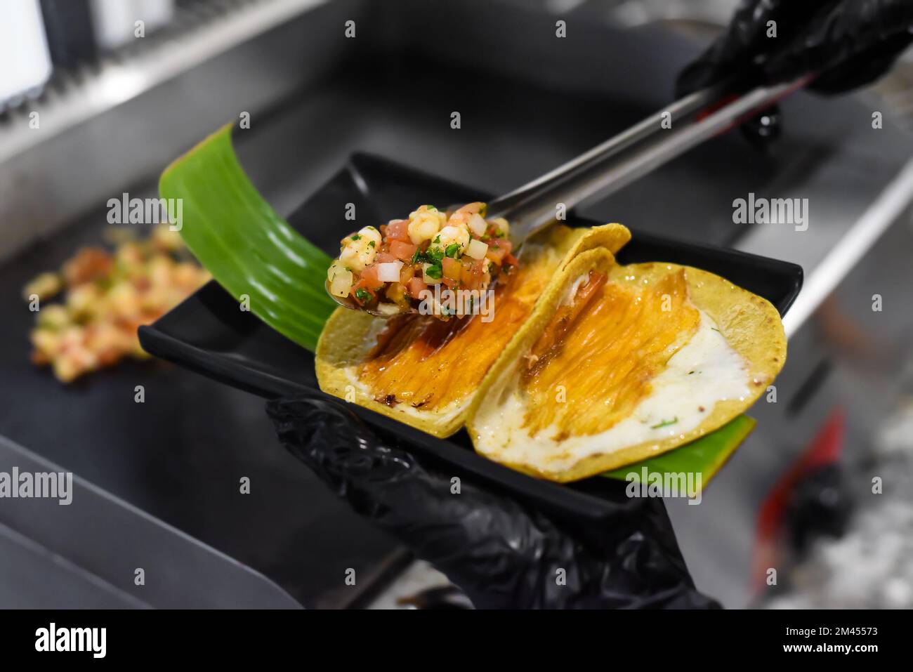 Hands cooking tacos in a mexican restaurant Stock Photo - Alamy