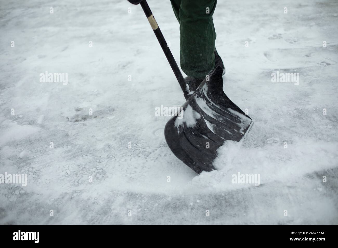 Snow shovel cleaning. Snow in yard in winter. Man cleans path from ...