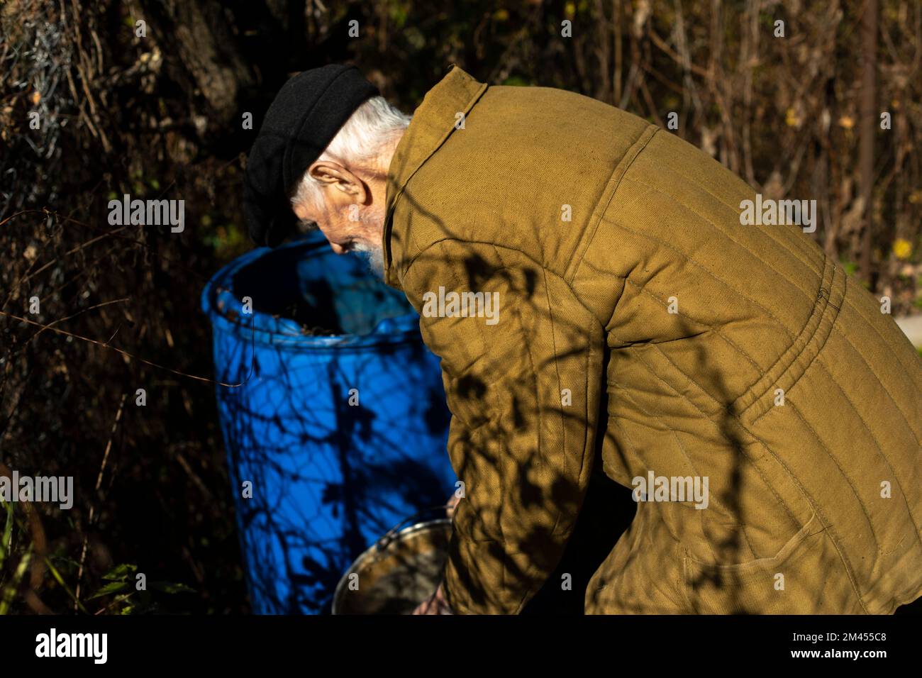 Old man at barrel of water. Old man in Russia. Man in 20th century ...