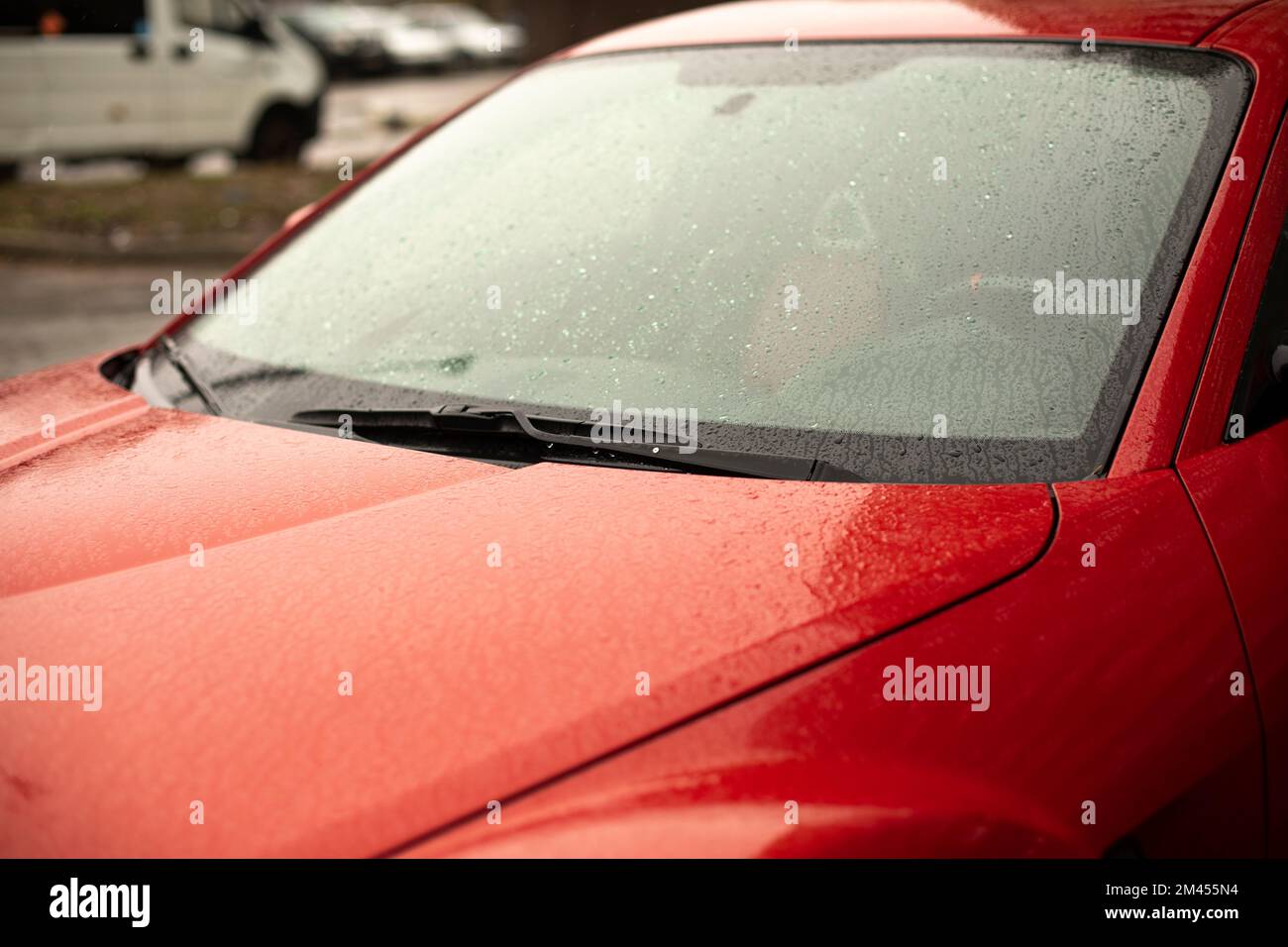 Red car. Wet car in parking lot. Windshield of transport Stock Photo ...