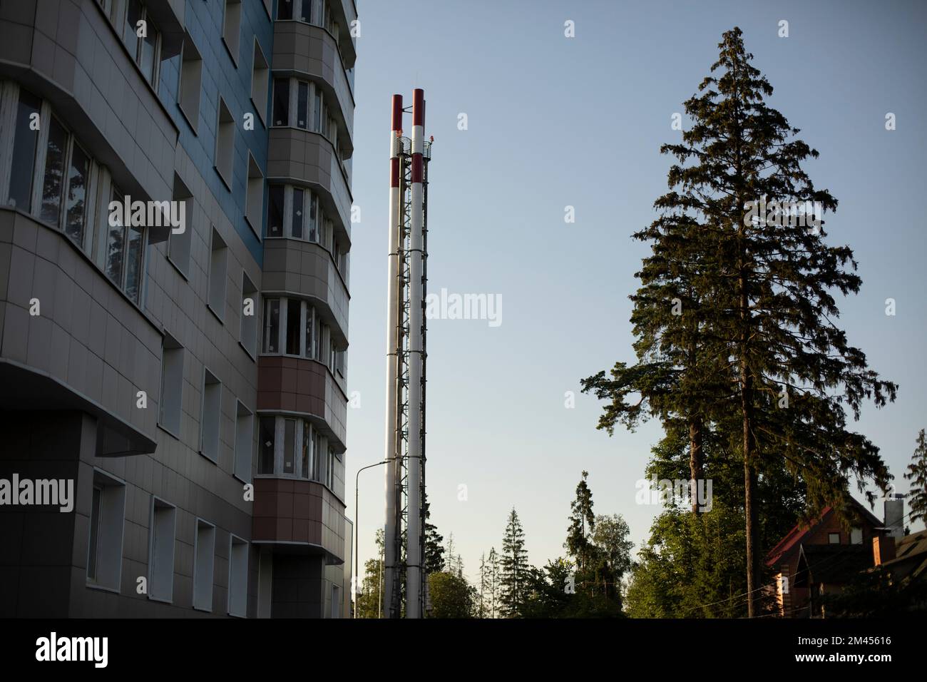 House and pipe. Boiler room near residential building. Steam pipe ...