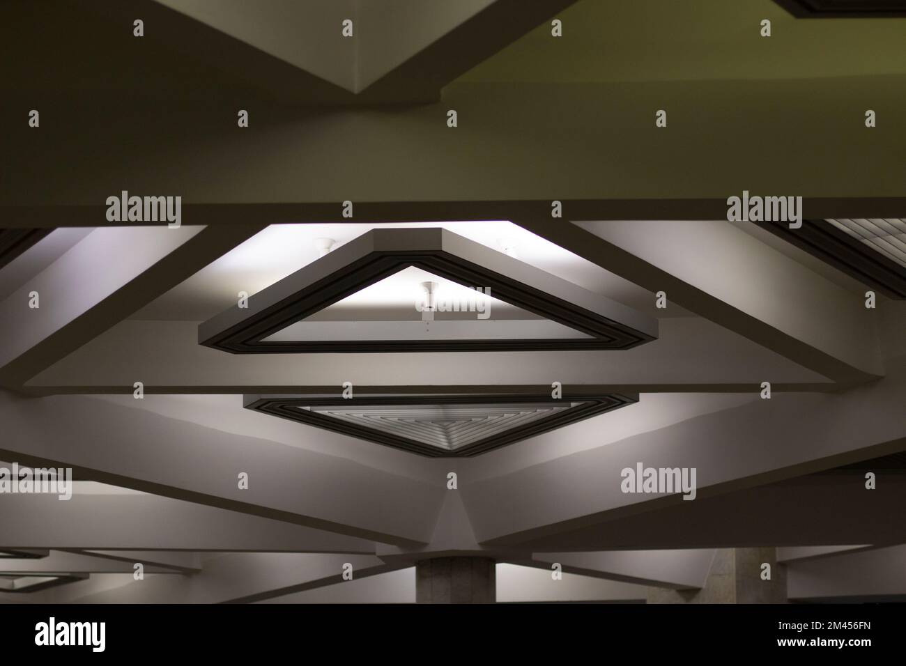 Interior light. Lamp is triangular. Ceiling details Stock Photo - Alamy
