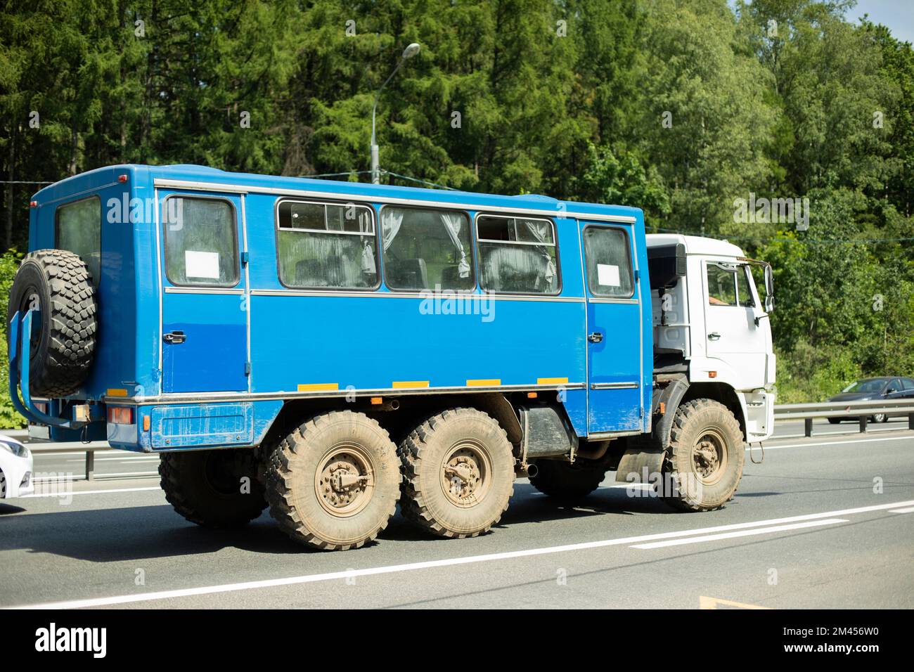 Truck on road. Car is driving on track. Transport with trailer ...