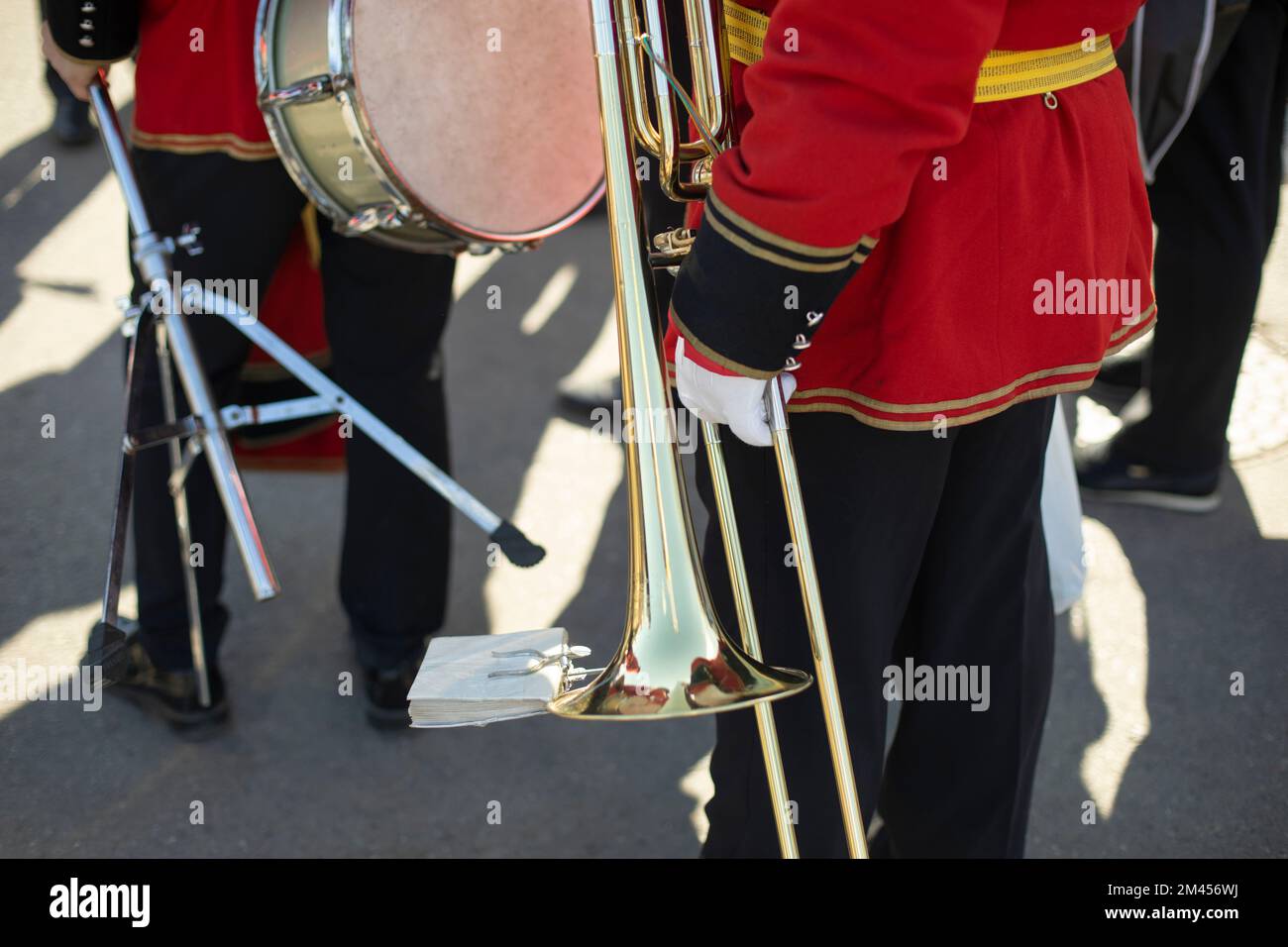 Orchestra member holds brass pipe. Trumpeter details. Ceremonial red ...