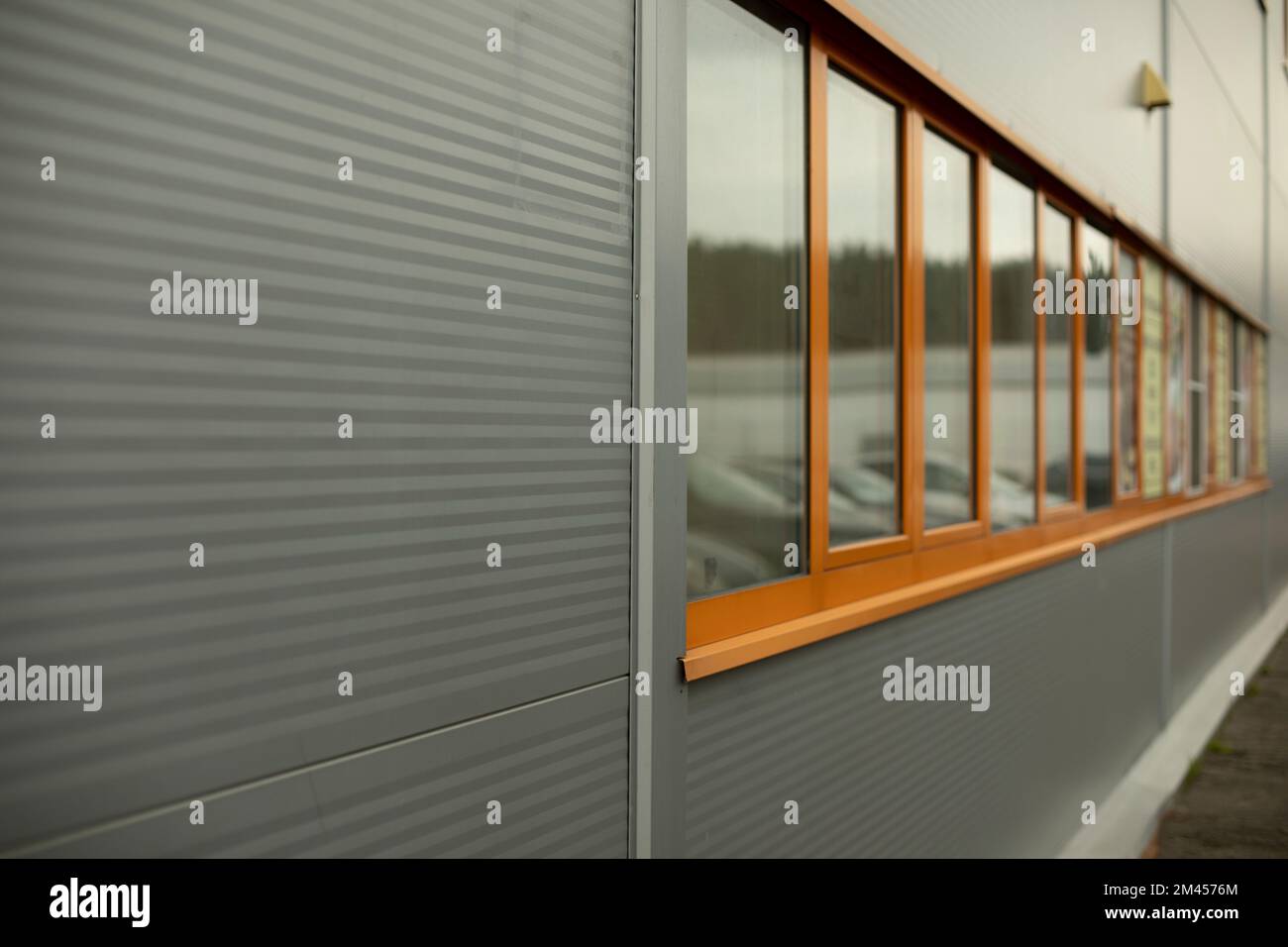 Orange window in building. Details of house. Industrial building. Wall ...