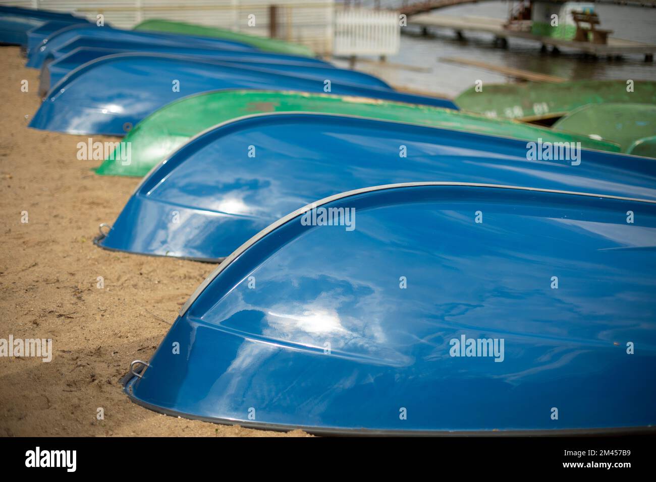 Blue boats on sand. Boat station. Boats dry up on shore Stock Photo - Alamy