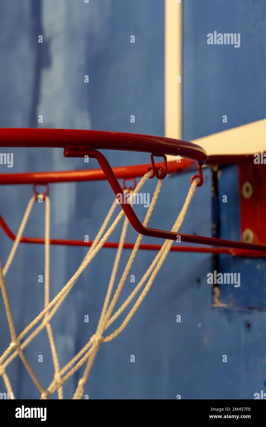 Plastic backboard with red hoop on outdoor basketball court with bright ...