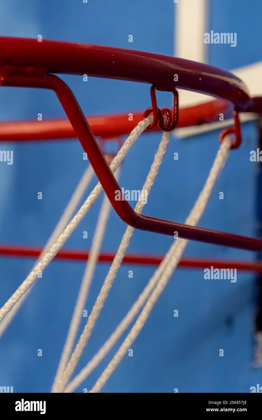 red basketball hoop with white woven net, detail background painting in ...