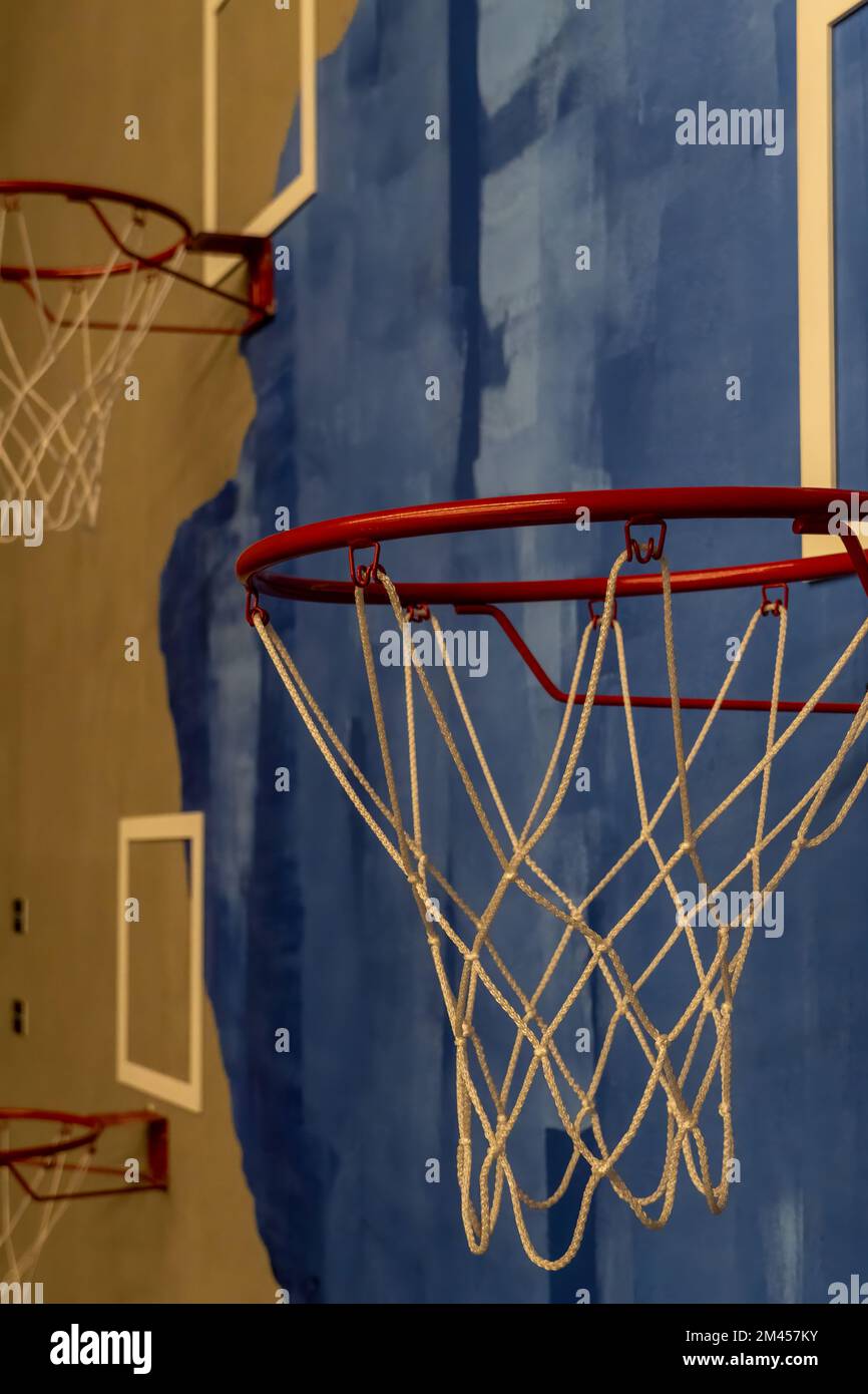 red basketball hoop with white woven net, detail background painting in ...