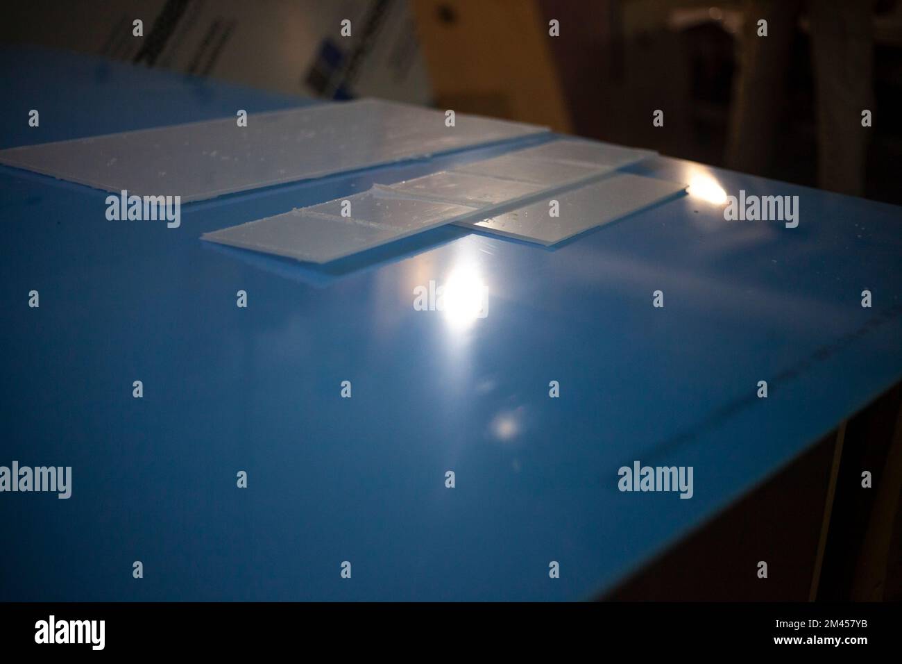 Plastic on table. Transparent material on desktop. Plastic production ...