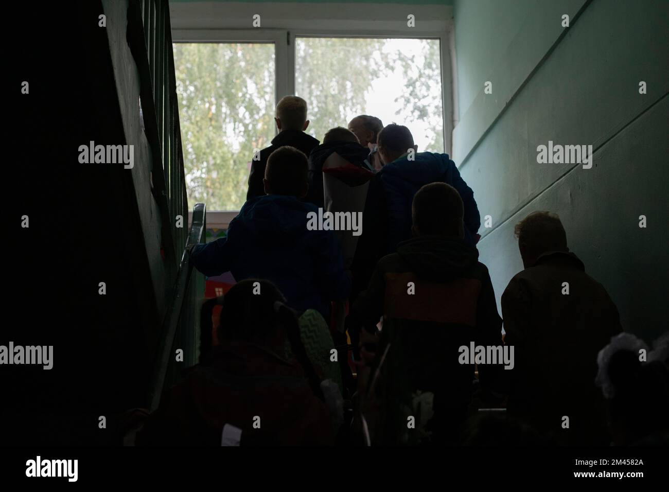 Schoolchildren go up stairs. Children in school building. Students go ...
