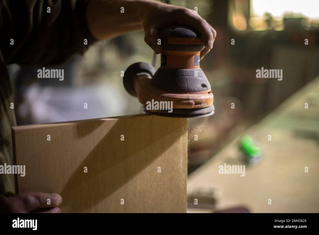 Grinding board. Wood processing. Electro tool in hand Stock Photo - Alamy