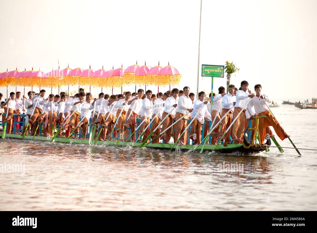 Peoples paddle by legs on the procession in Phaung Daw Oo Festival ,Inle lake ,Myanmar. The ...