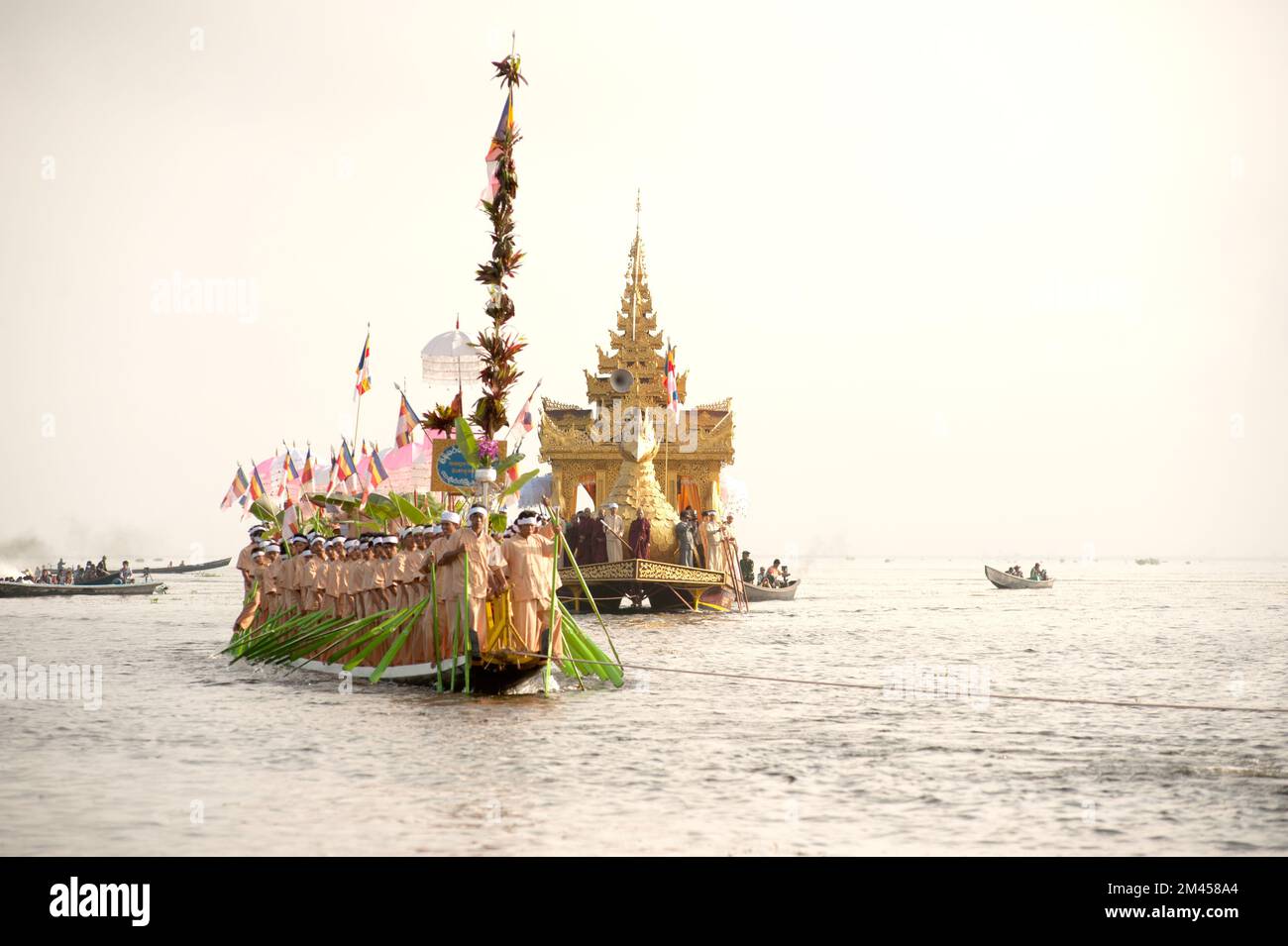 Peoples paddle by legs on the procession in Phaung Daw Oo Festival ...