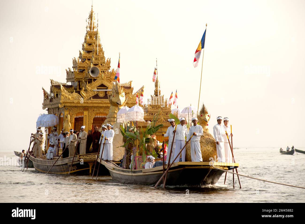 Peoples paddle by legs on the procession in Phaung Daw Oo Festival ,Inle lake ,Myanmar. The ...