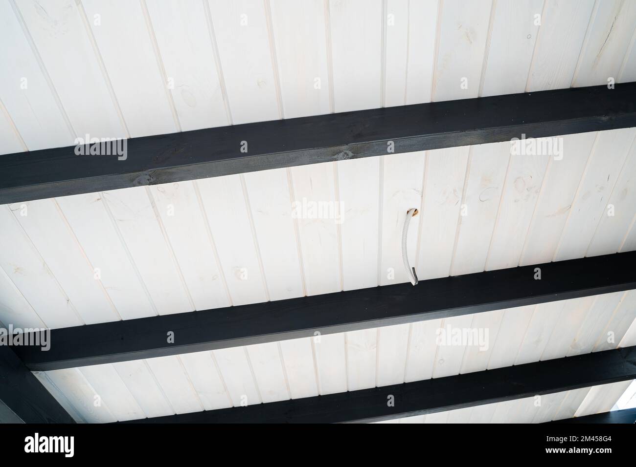 The ceiling of the street terrace is made of white wooden lining and ...