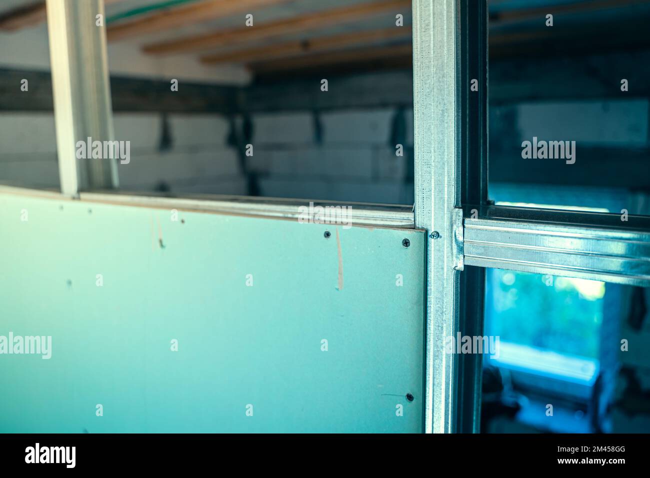 The beginning of the process of sheathing the frame with drywall. One ...