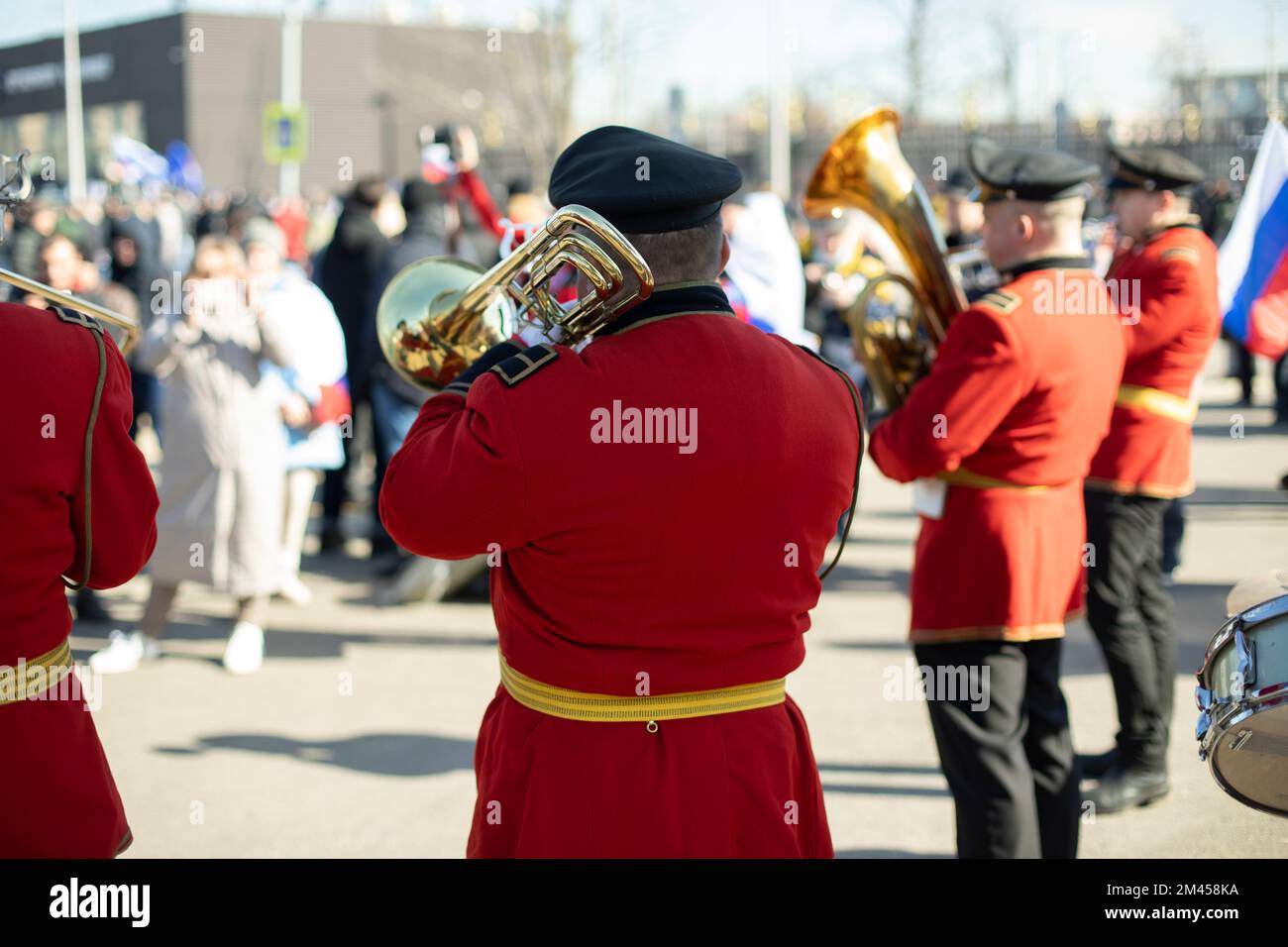 Orchestra with wind instruments. Trumpeters in ceremonial uniforms. Red ...
