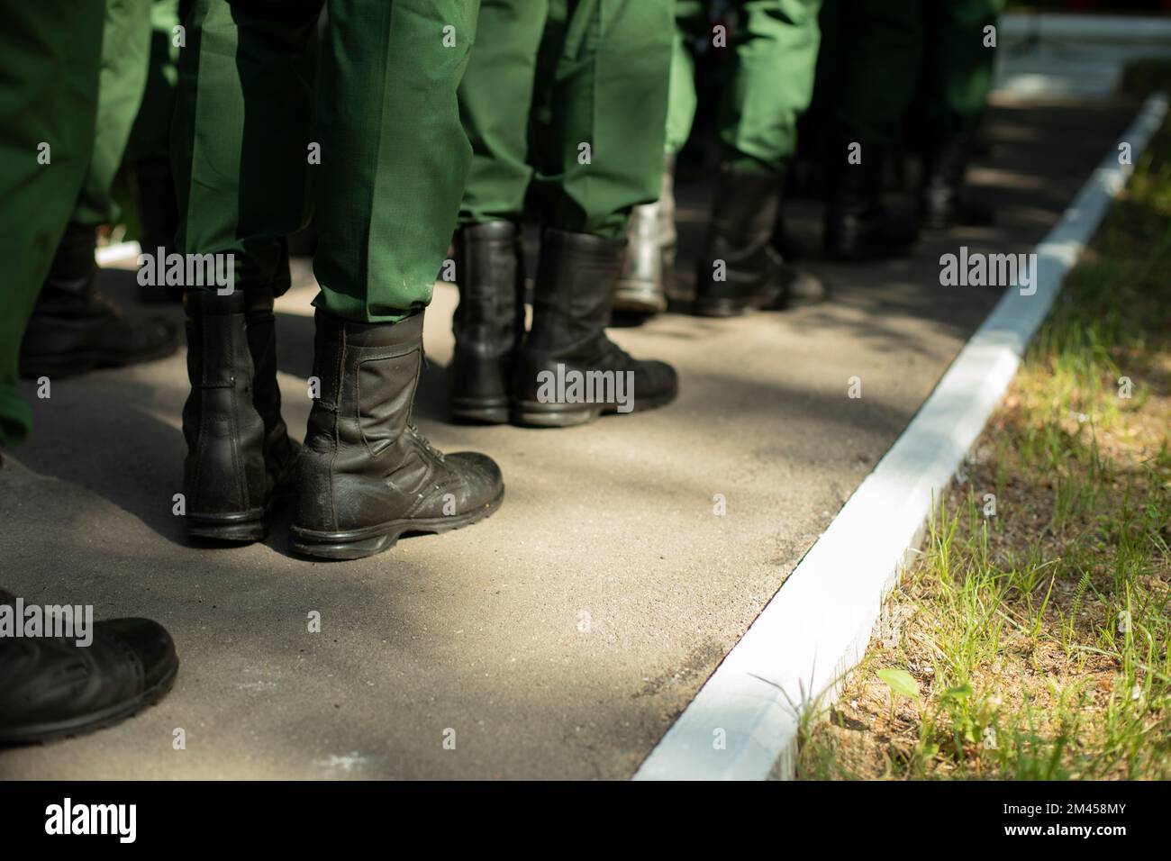Military stands in row. Soldiers' shoes. Boots and military uniforms ...