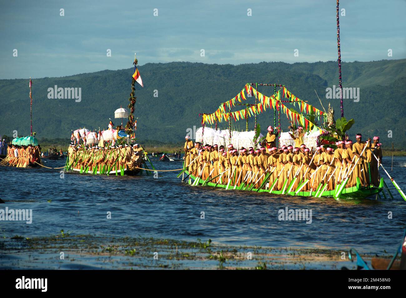 Peoples paddle by legs on the procession in Phaung Daw Oo Festival ...
