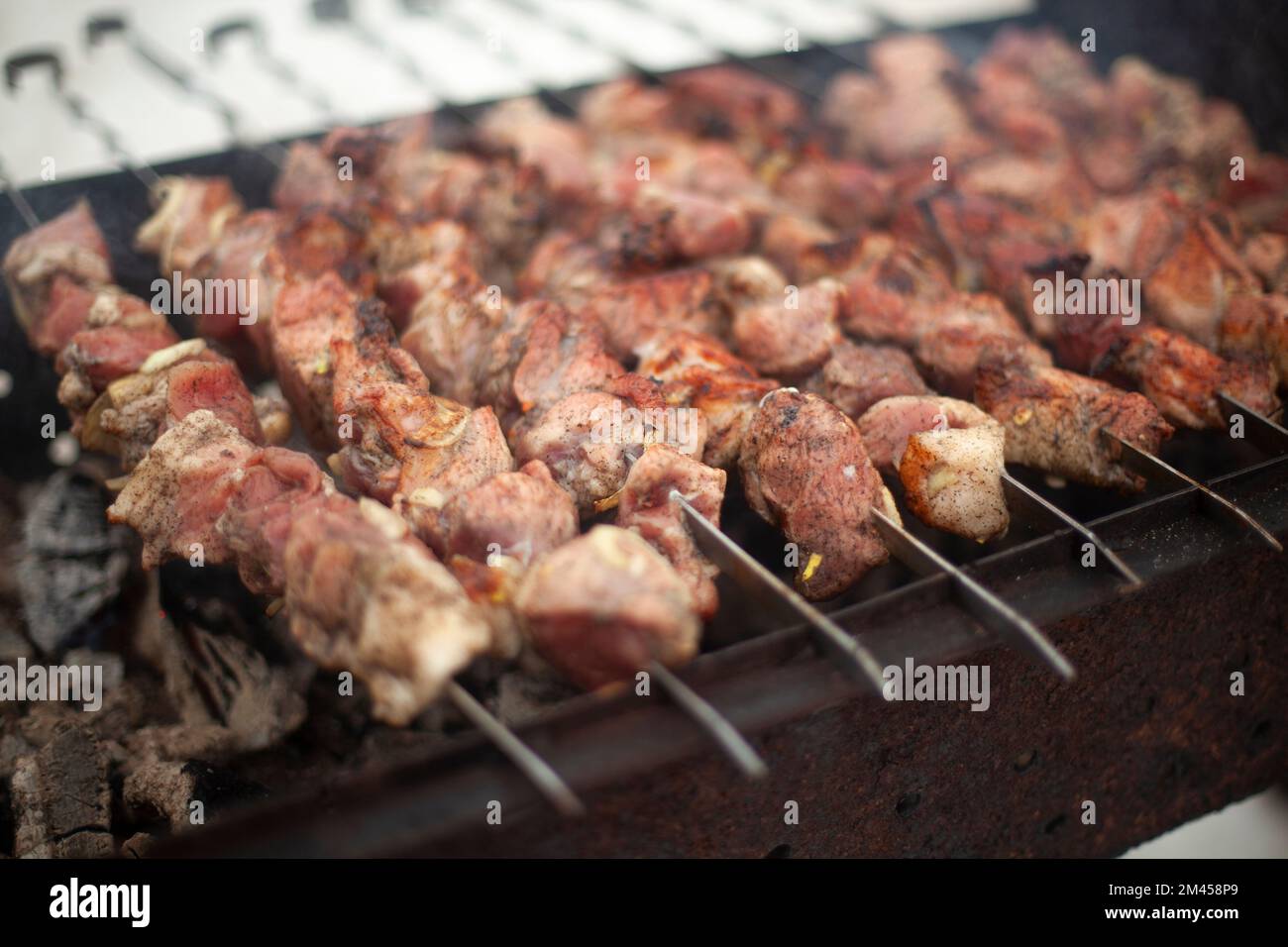 Meat is fried outside. Raw meat planted on blades. Heating food on ...