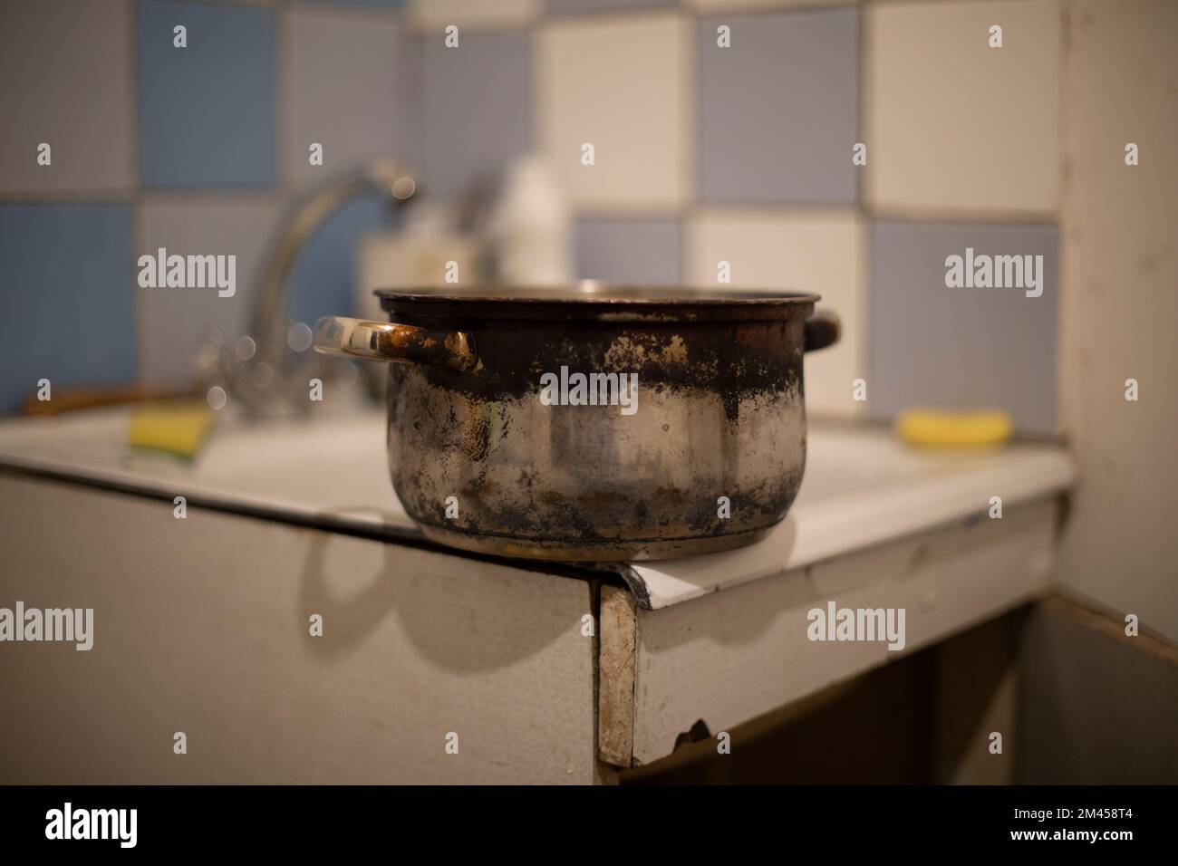 Old pan on sink. Dishes in kitchen. Old kitchen in house. Burnt pot ...