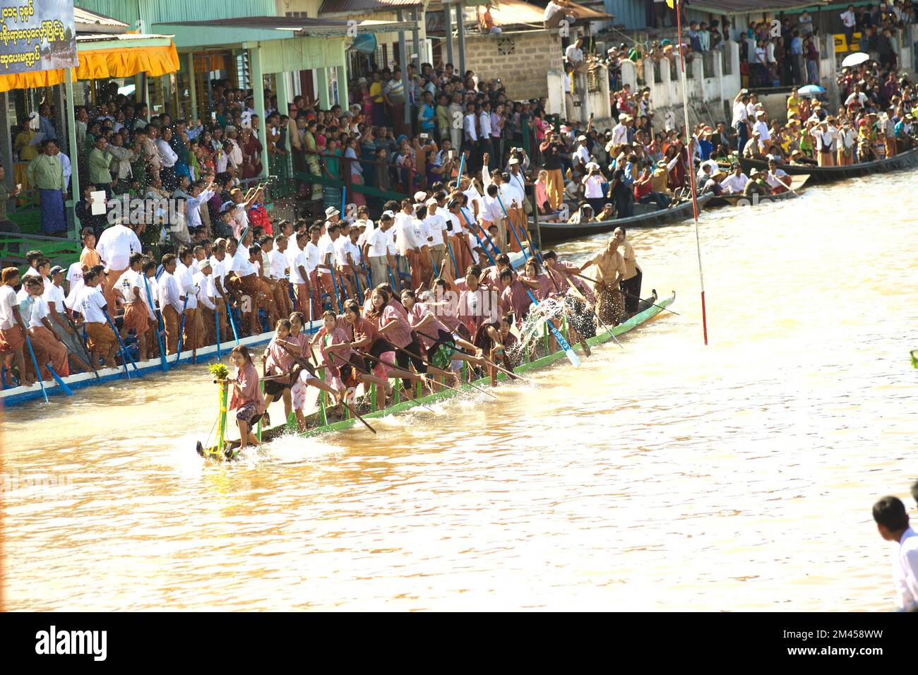 Peoples paddle by legs on the procession in Phaung Daw Oo Festival ,Inle lake ,Myanmar. The ...