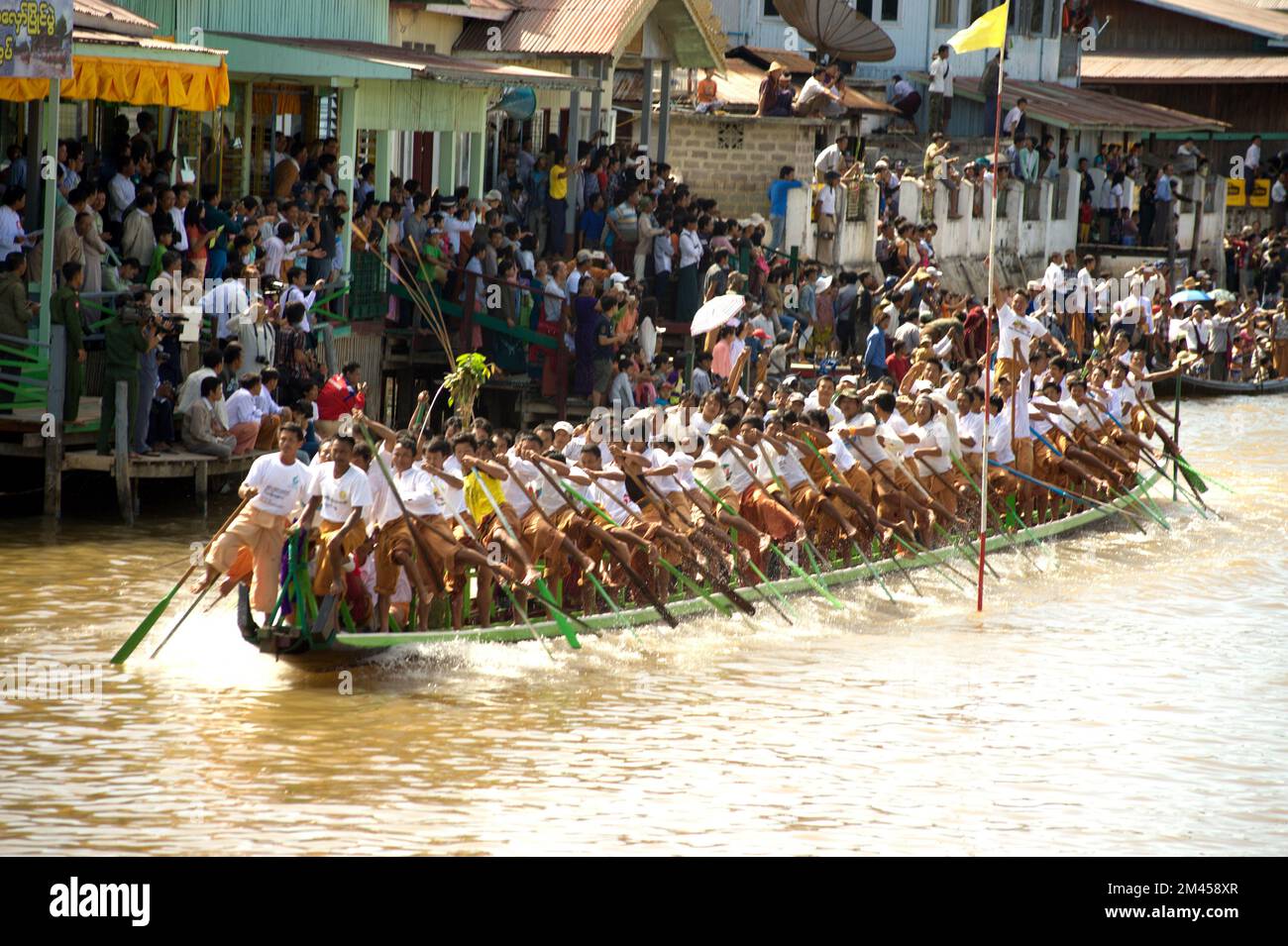 Peoples paddle by legs on the procession in Phaung Daw Oo Festival ,Inle lake ,Myanmar. The ...