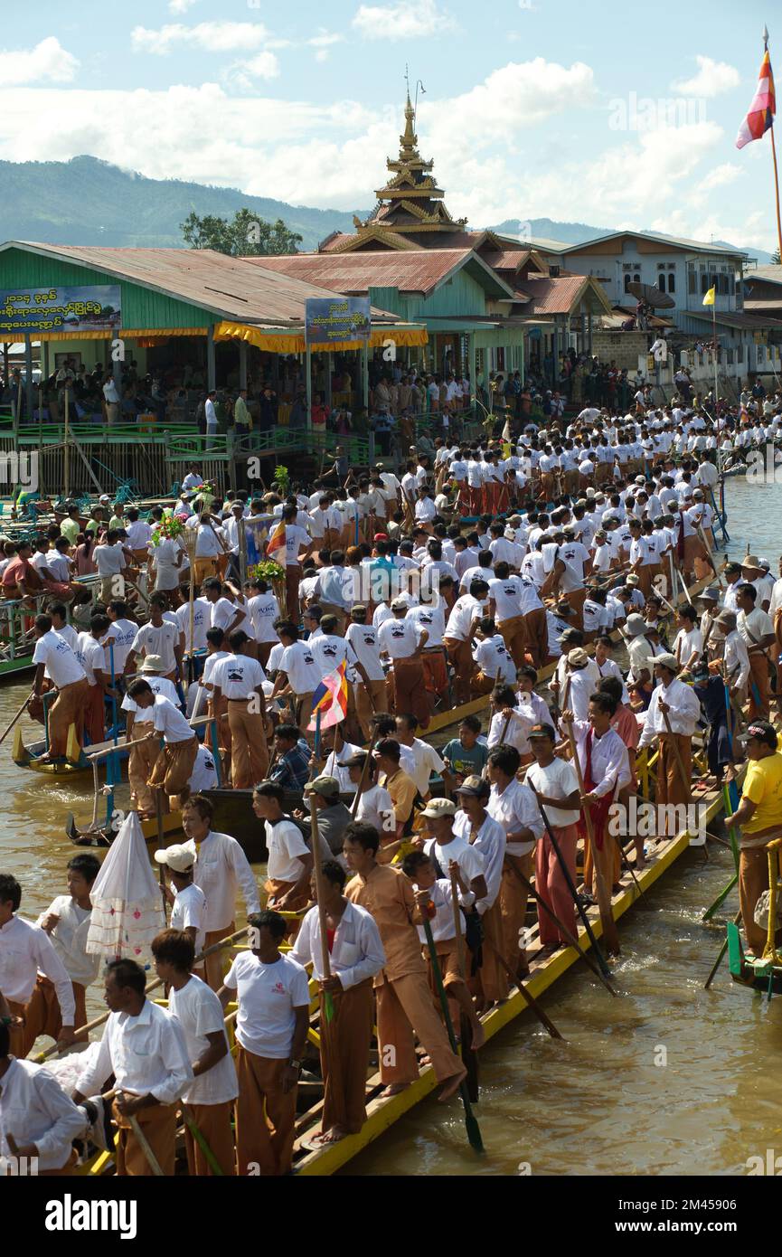 Peoples paddle by legs on the procession in Phaung Daw Oo Festival ,Inle lake ,Myanmar. The ...