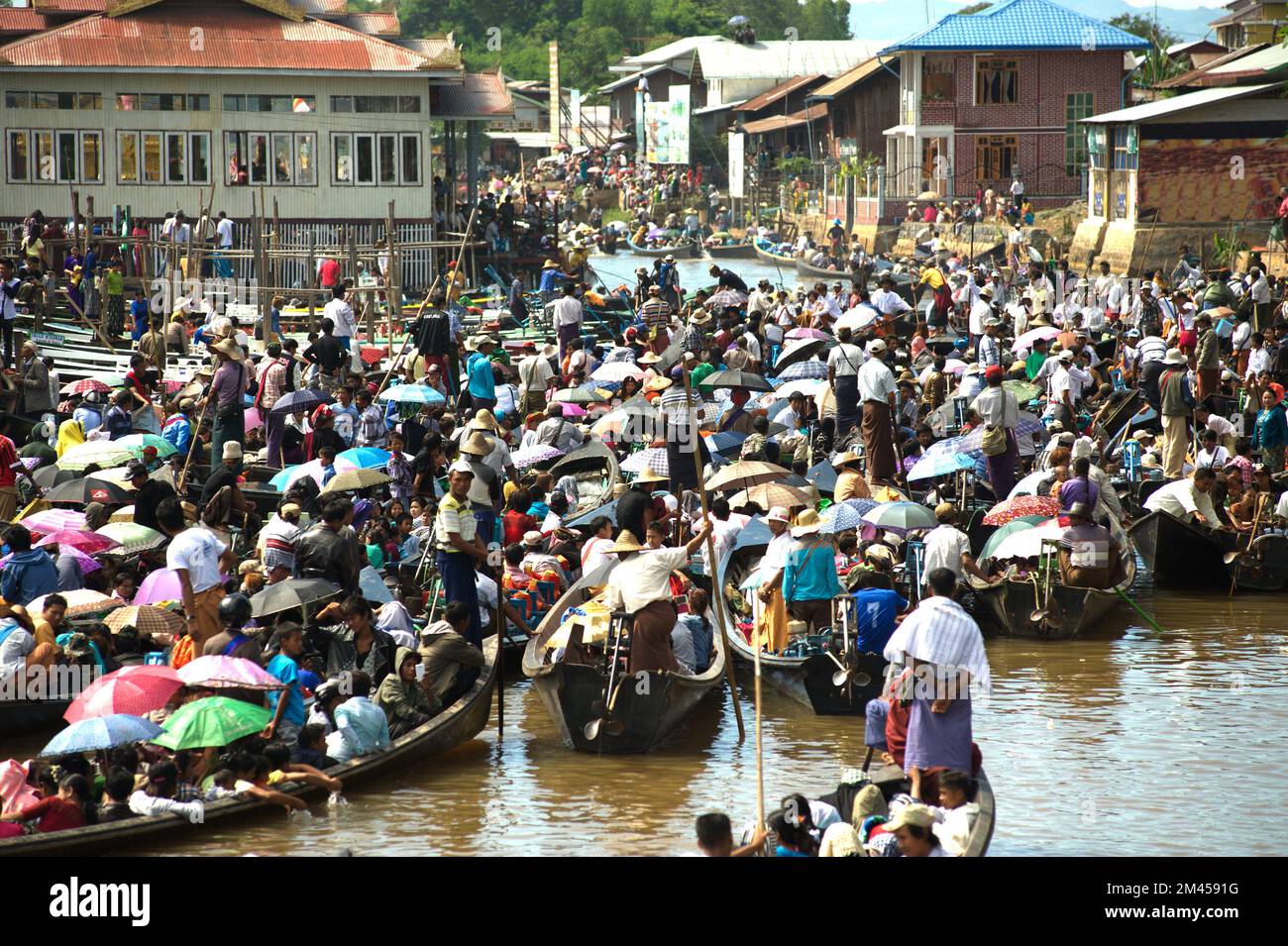 Peoples paddle by legs on the procession in Phaung Daw Oo Festival ...