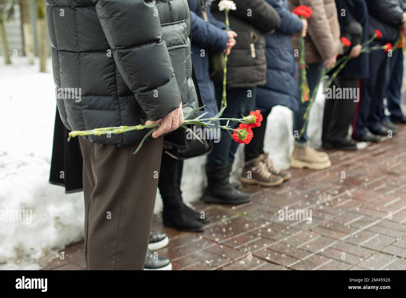 Flowers in old man's hand at funeral. Details of funeral ceremony ...