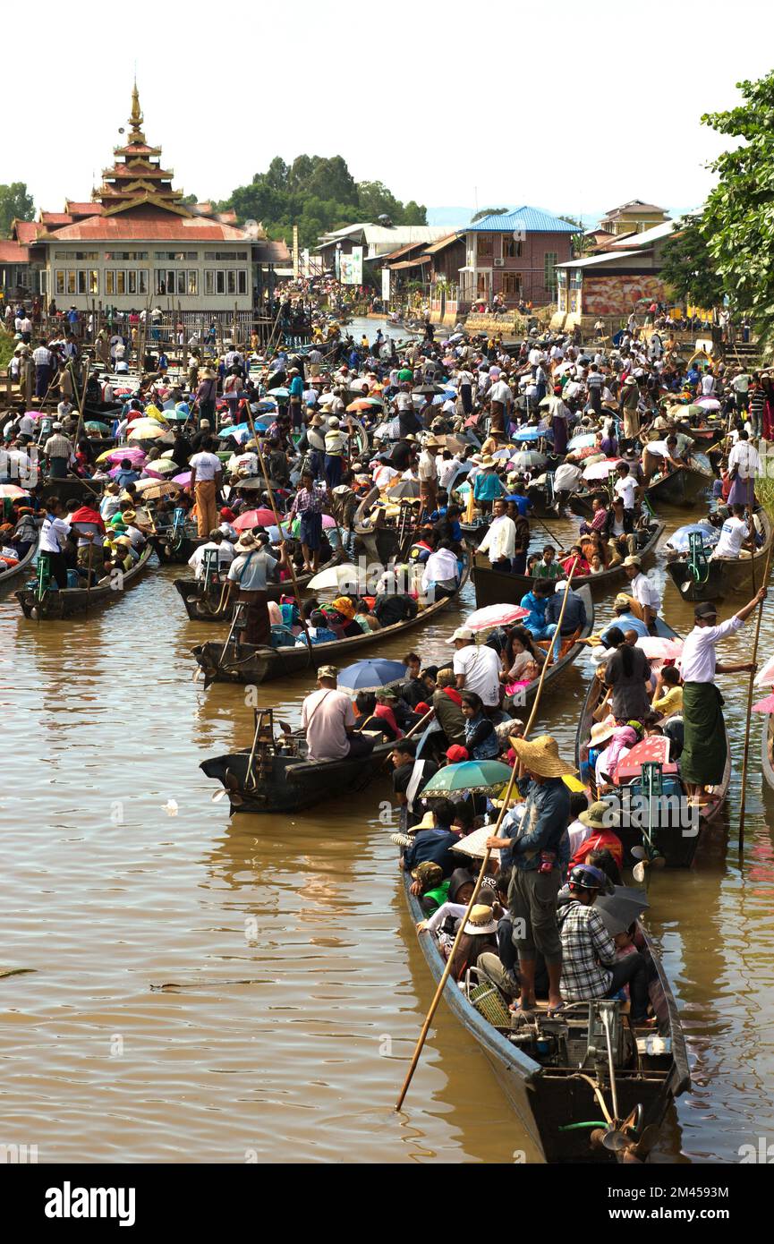 Peoples paddle by legs on the procession in Phaung Daw Oo Festival ,Inle lake ,Myanmar. The ...