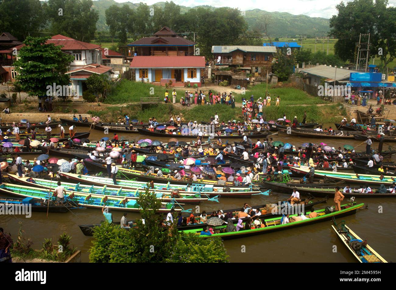 Peoples paddle by legs on the procession in Phaung Daw Oo Festival ...