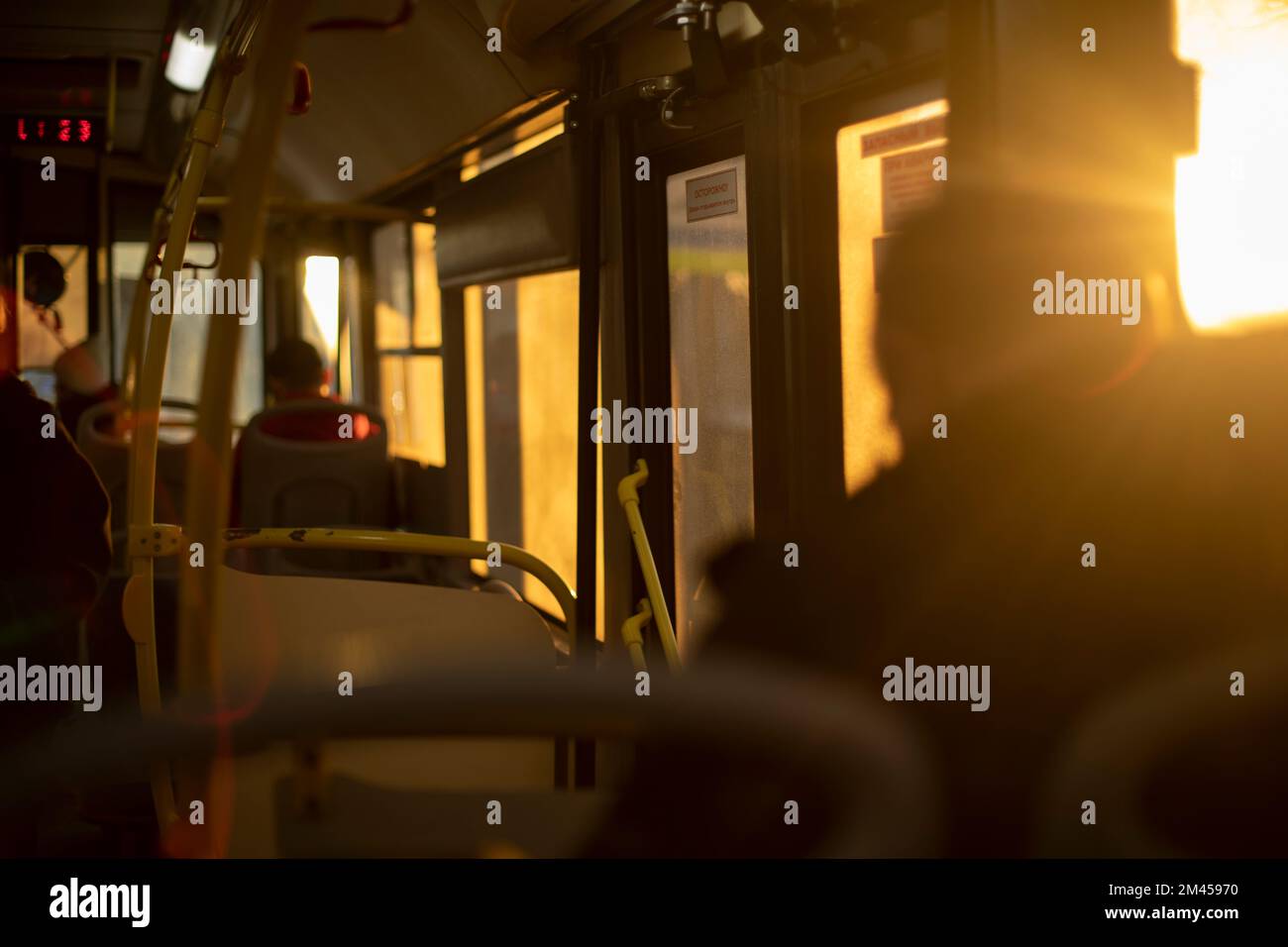 Inside bus is light of sun. People in transport. Details of interior of ...