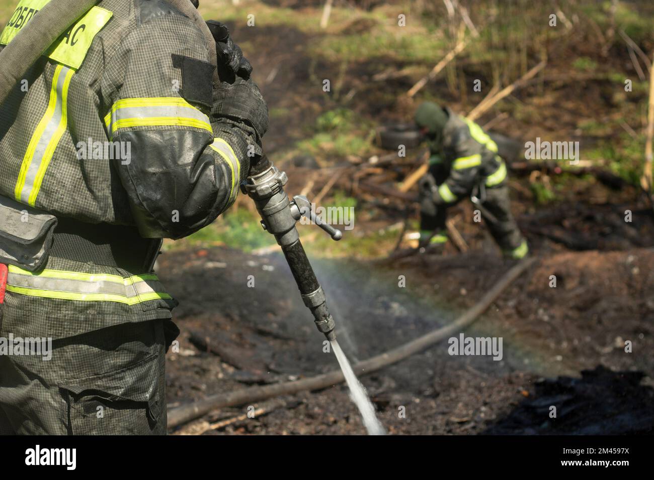 Firefighter pours water from hose. Extinguishing fire in detail. Water ...