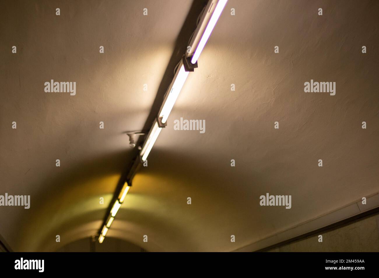 Lamps on ceiling of tunnel. Details of interior of metro. Fluorescent ...
