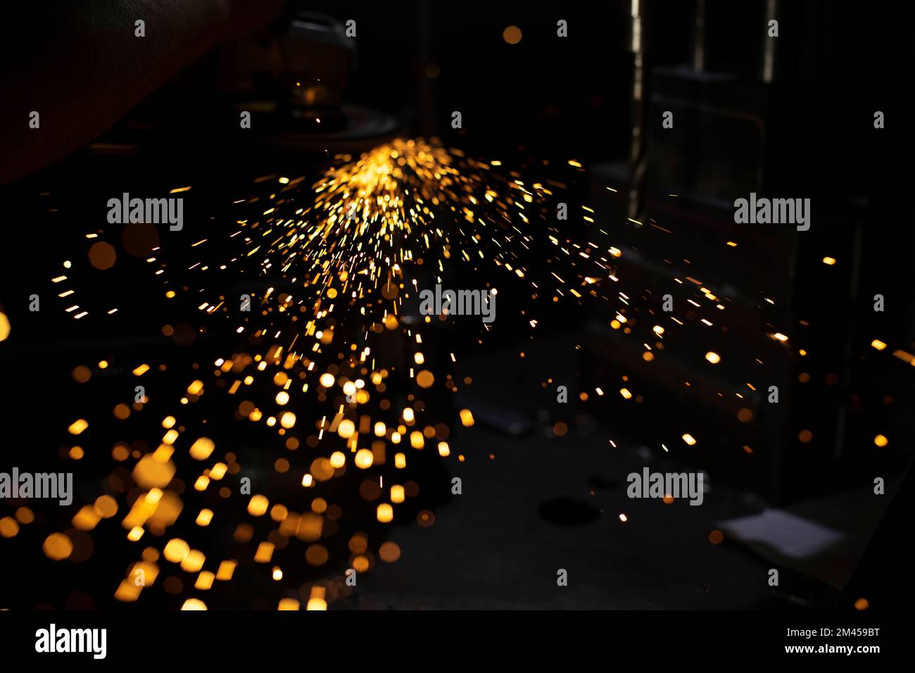 Metal treatment. Grinding of steel. Sparks from disk. Work in workshop ...