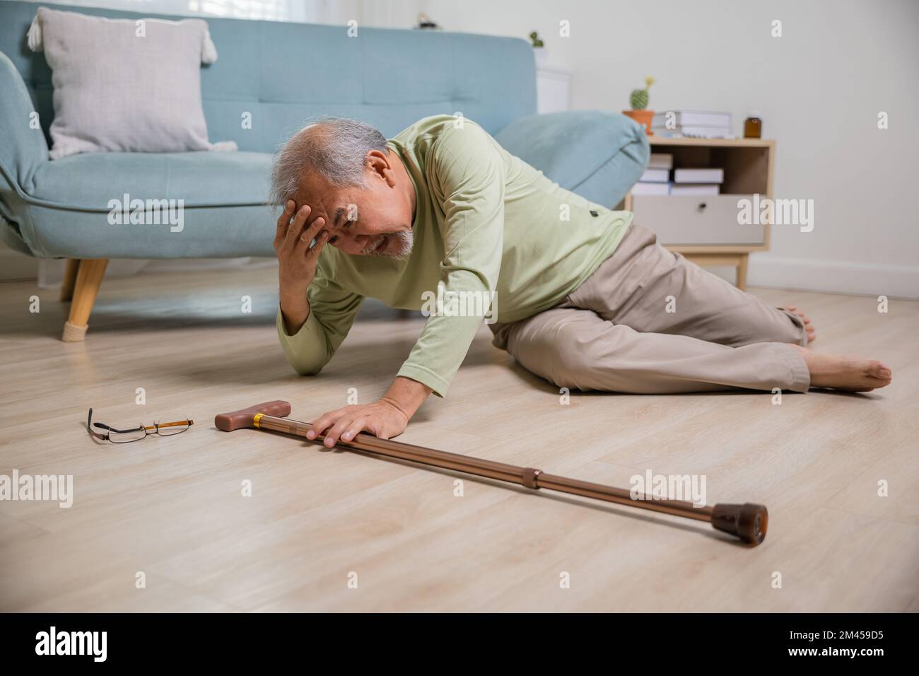 Sick senior old man falling down lying on floor because stumbled at ...